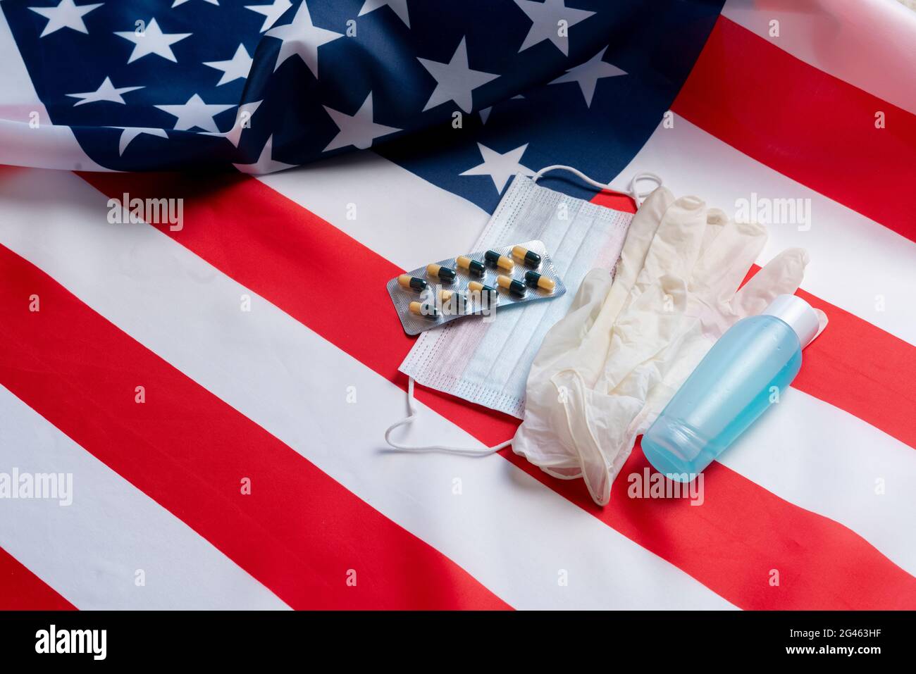 antiseptic gloves and mask on the american flag as symbol of quarantine ...