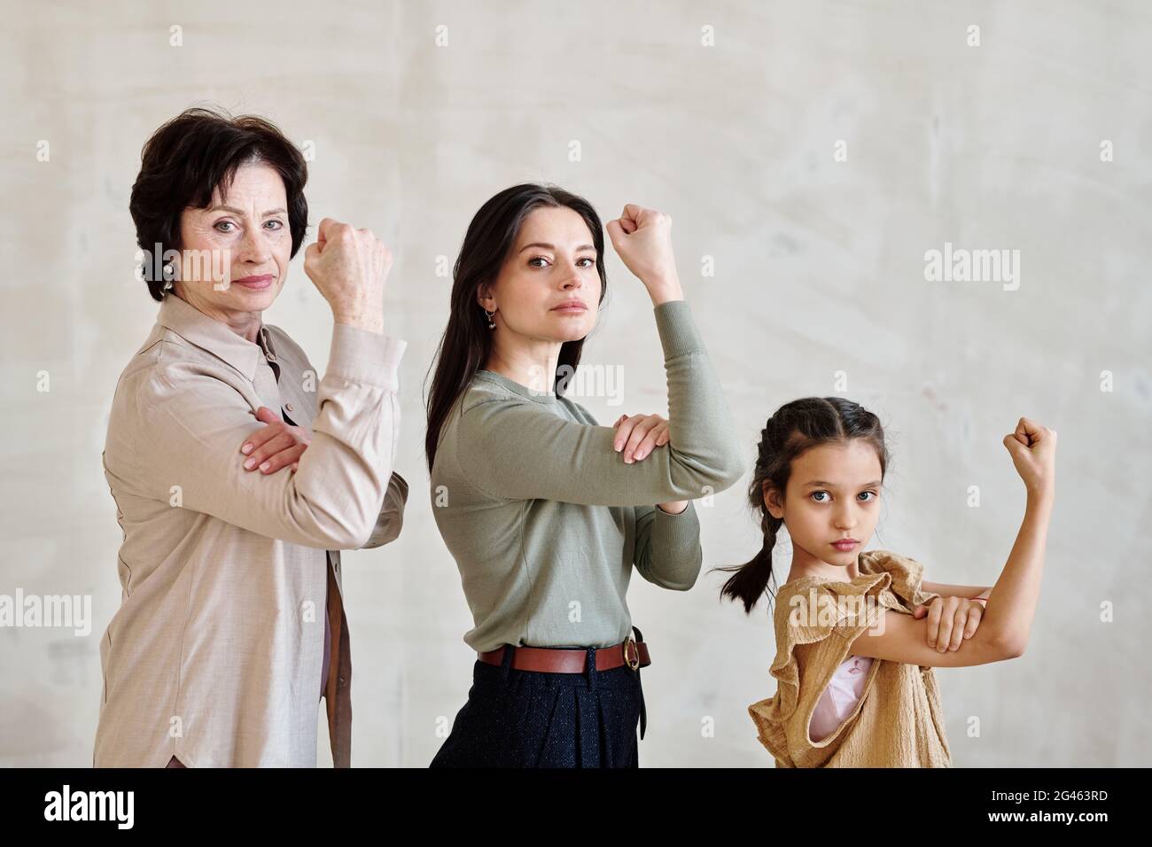 Three serious females showing their strength Stock Photo - Alamy