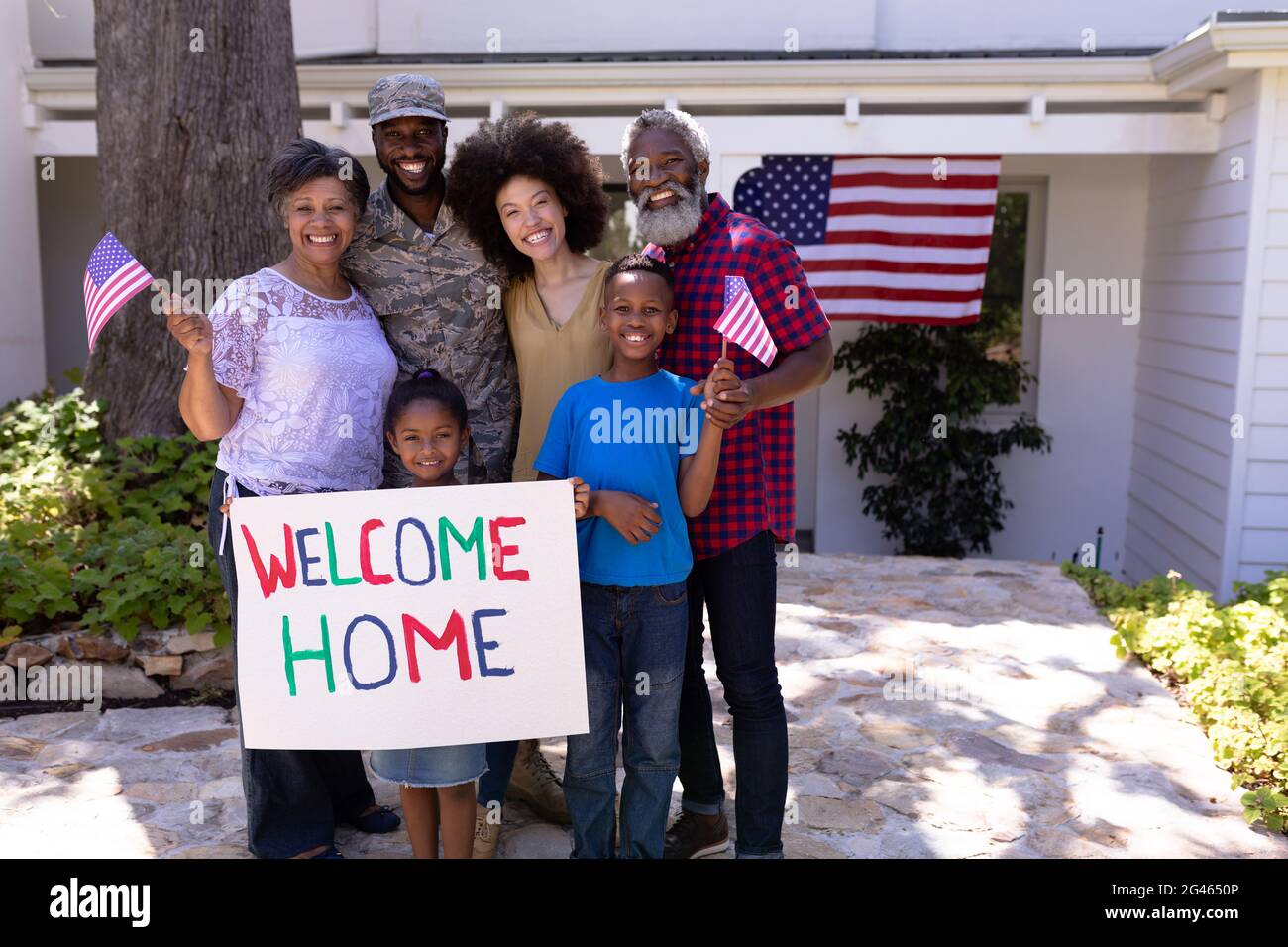 Multi-generation mixed race family welcoming an African American man ...