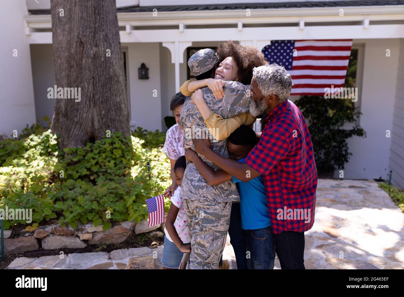 Multi-generation mixed race family welcoming an African American man ...