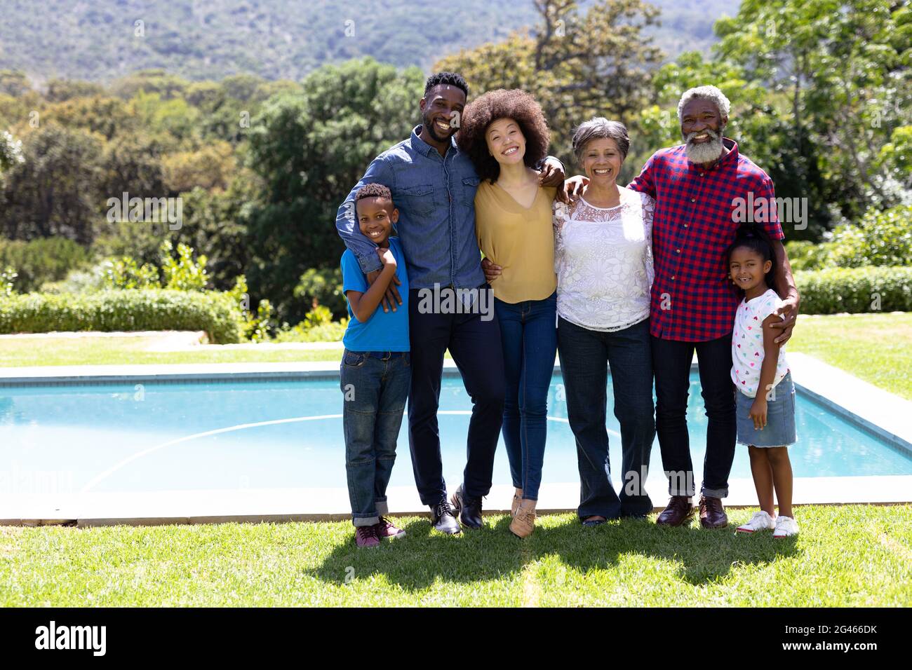 Multi-generation mixed race family enjoying their time at a garden ...