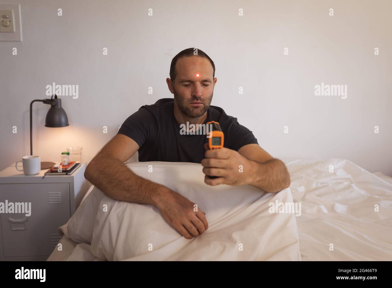Sick Caucasian man self isolating and social distancing in quarantine ...