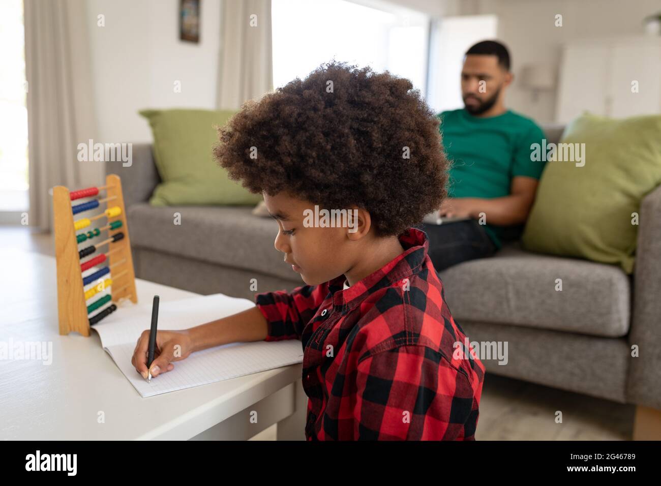 Boy doing homework at home Stock Photo - Alamy
