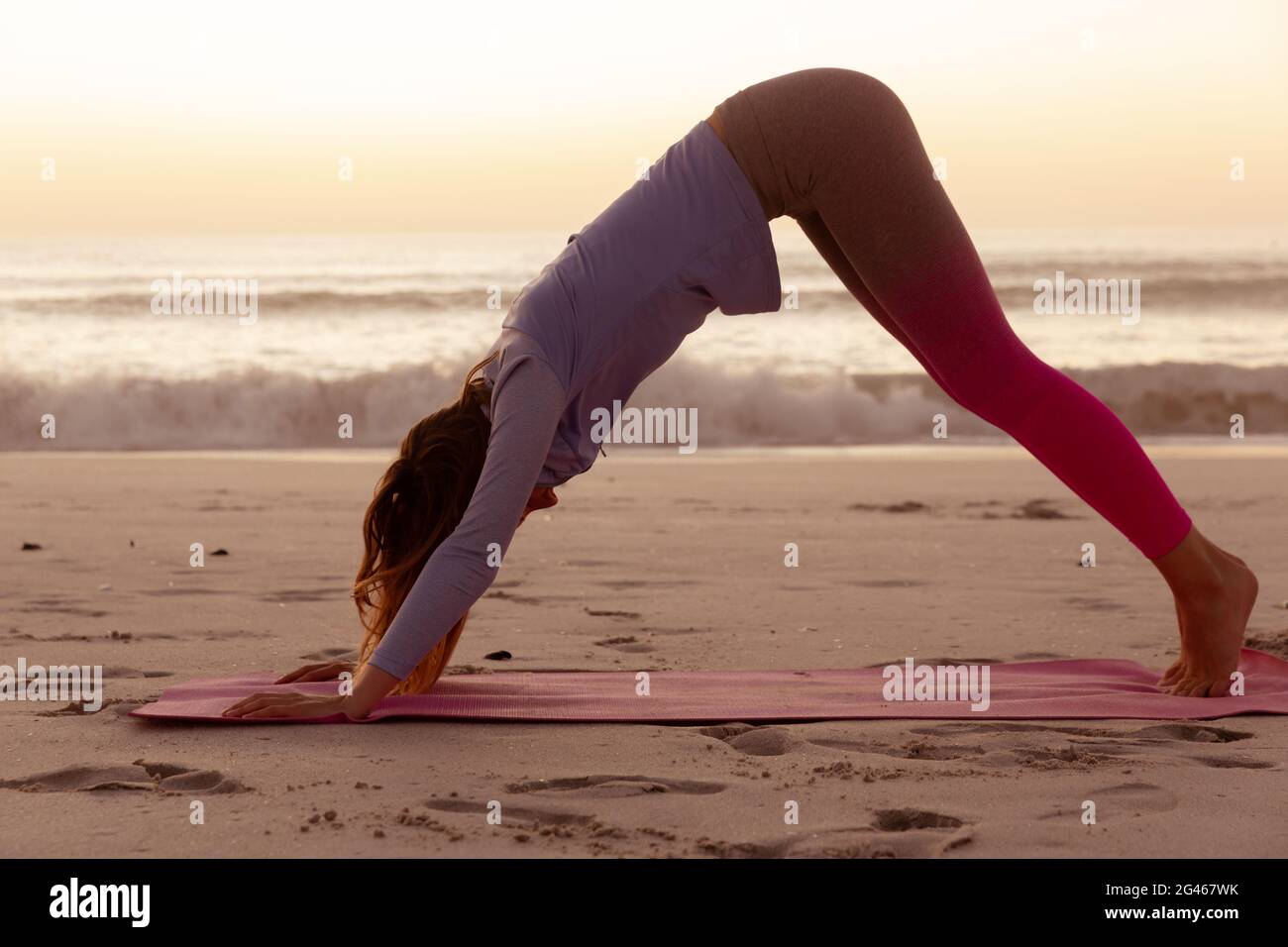 Woman performing yoga on beach hi-res stock photography and images - Alamy