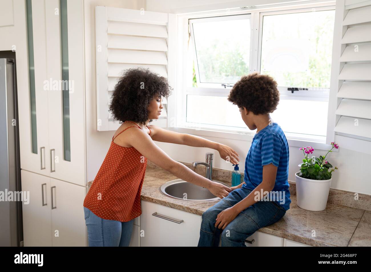 Mother helping son to wash his hands at home Stock Photo - Alamy
