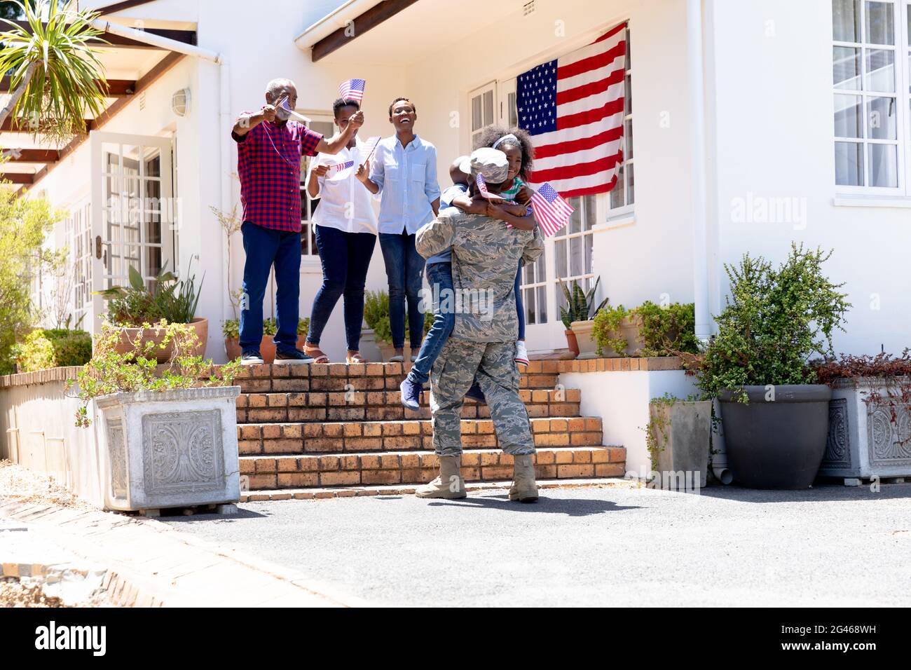 African American male soldier wearing uniform and his family standing ...