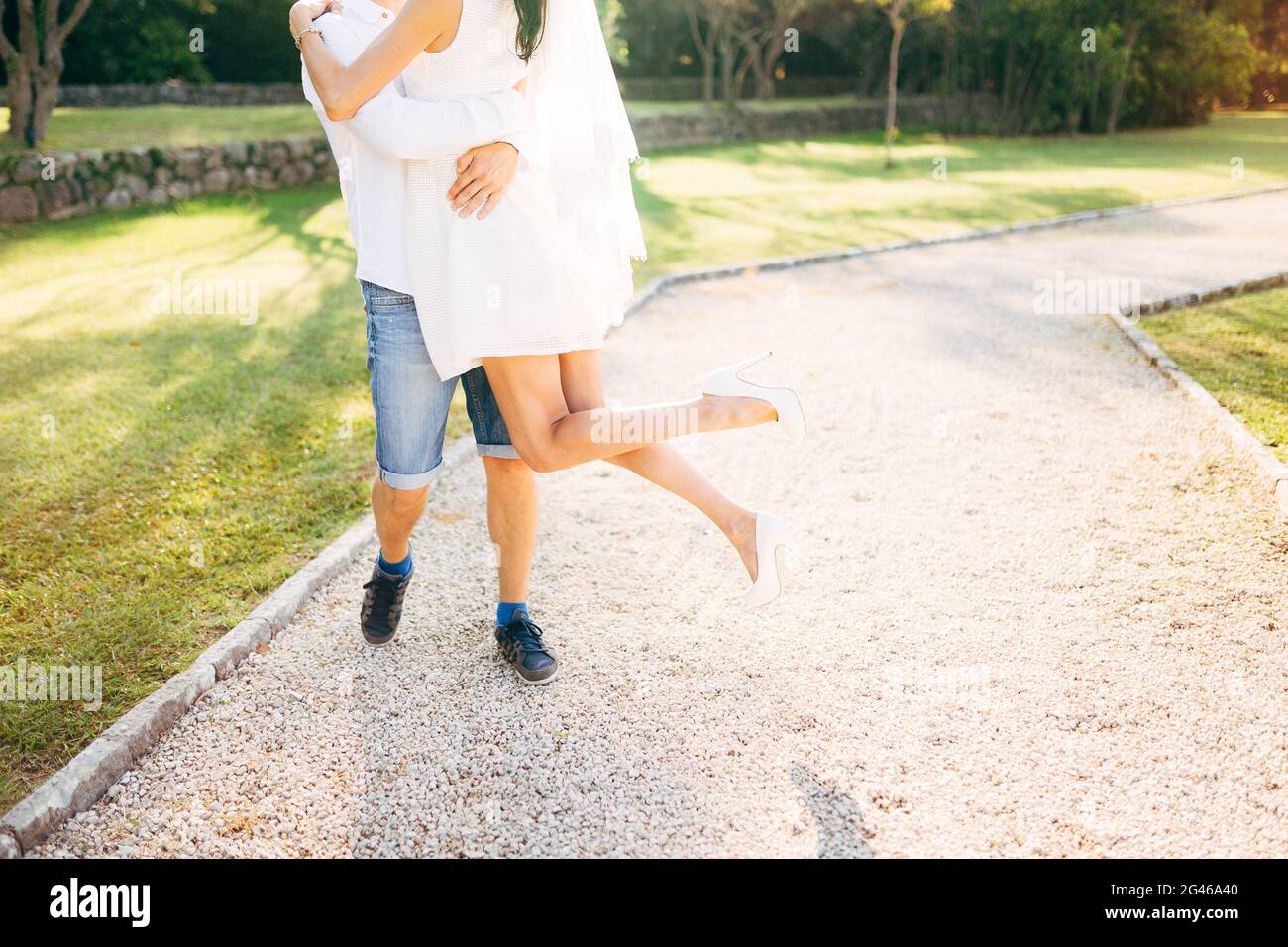 The groom lifted the bride in his arms. Legs close-up. Wedding i Stock ...