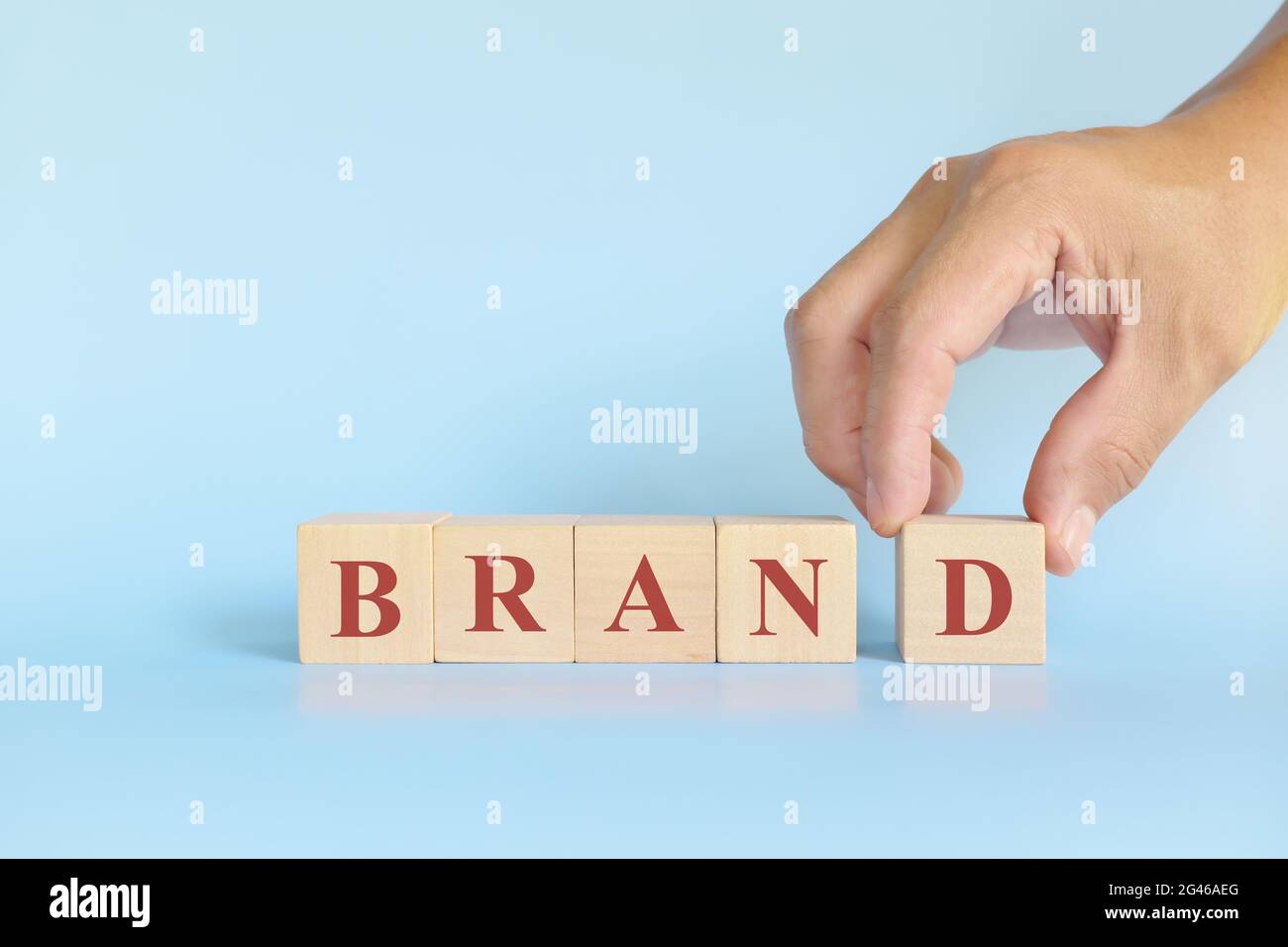 Brand building success in business concept. Hand stacking wooden blocks ...