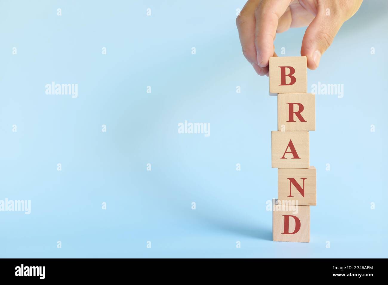 Brand building success in business concept. Hand stacking wooden blocks ...