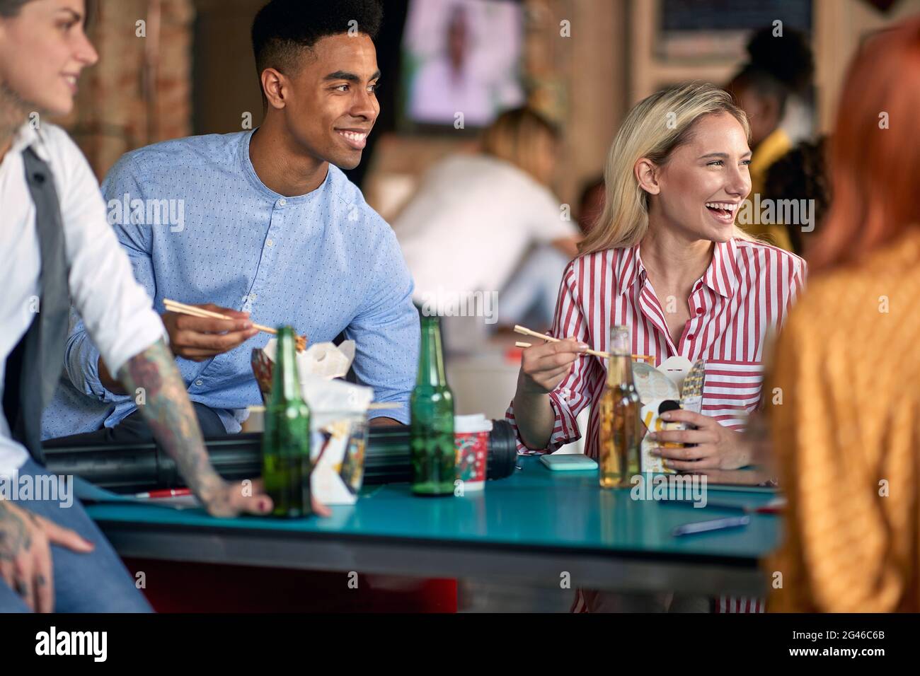Young colleagues having a good time during a lunch break in a cheerful ...