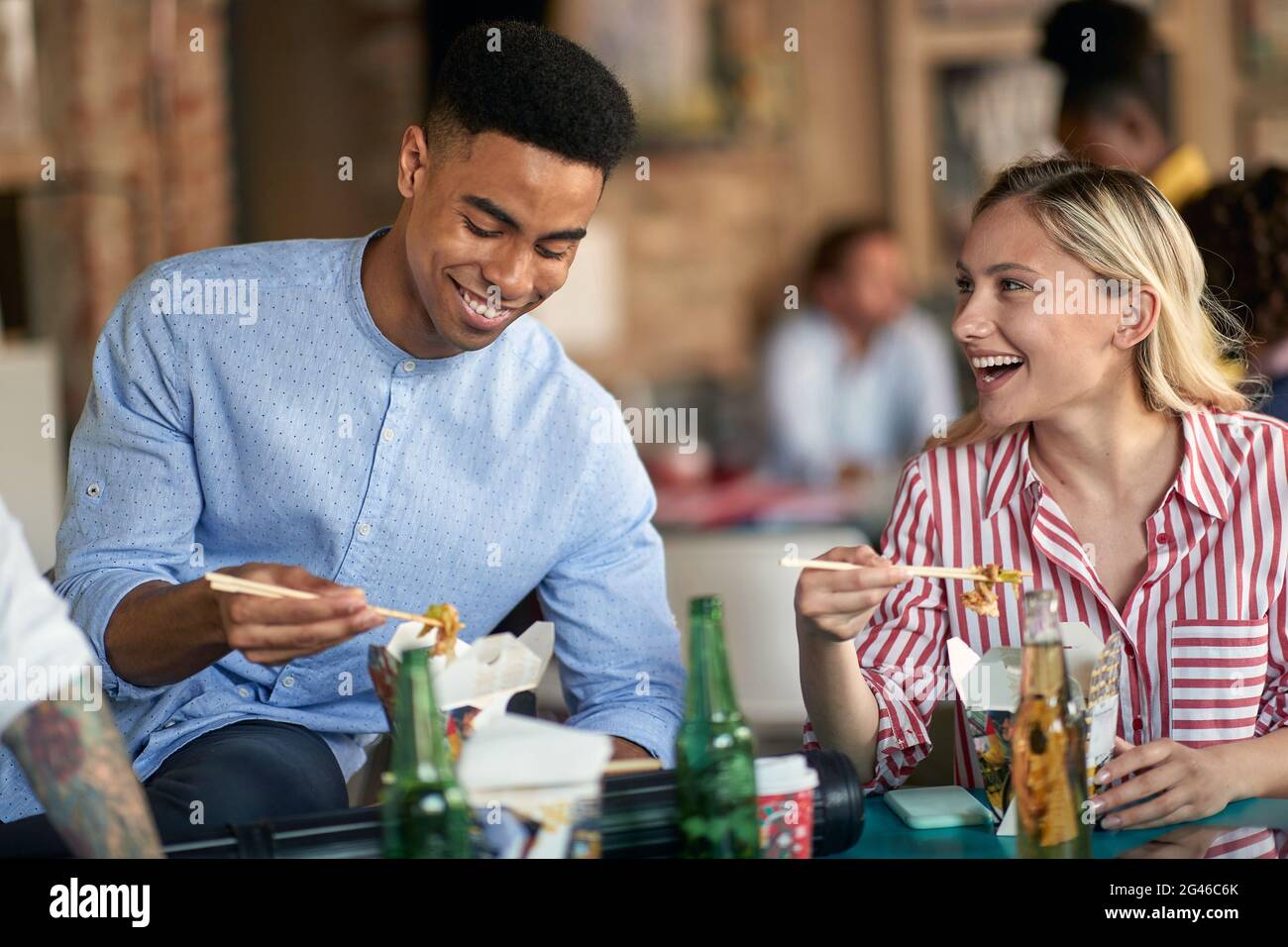 Young colleagues enjoying a lunch break in a relaxed atmosphere in the ...
