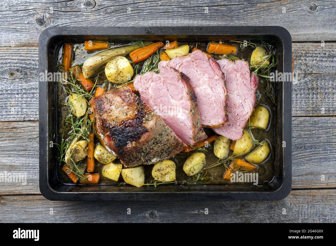 Traditional corned pot pork roast sliced and offered with potatoes ...