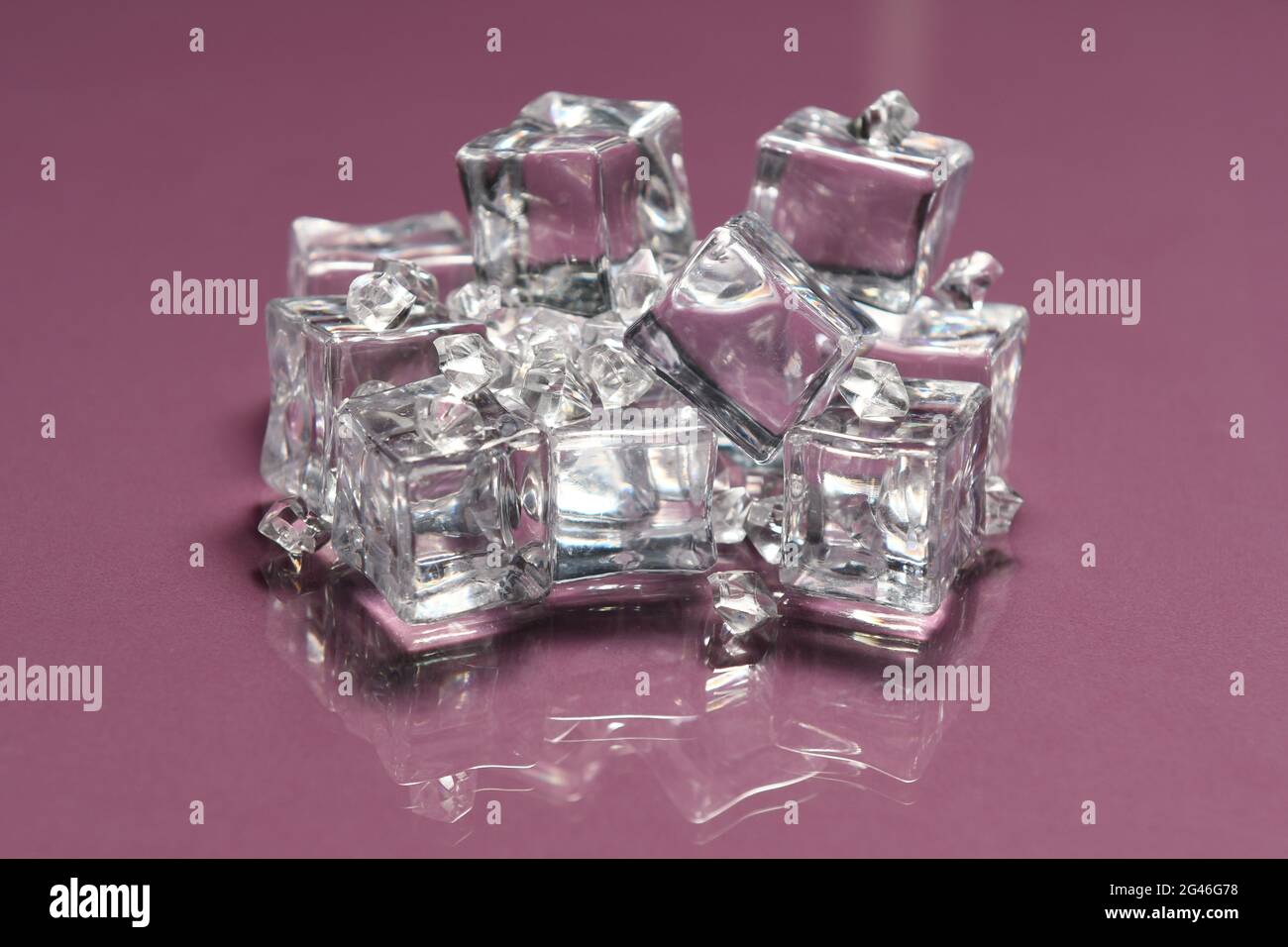 ice stone on reflective surface of background with drops, idea of a ...