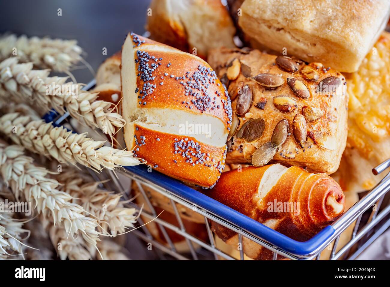 Assortment traditional breads and buns with grains on a wooden board ...