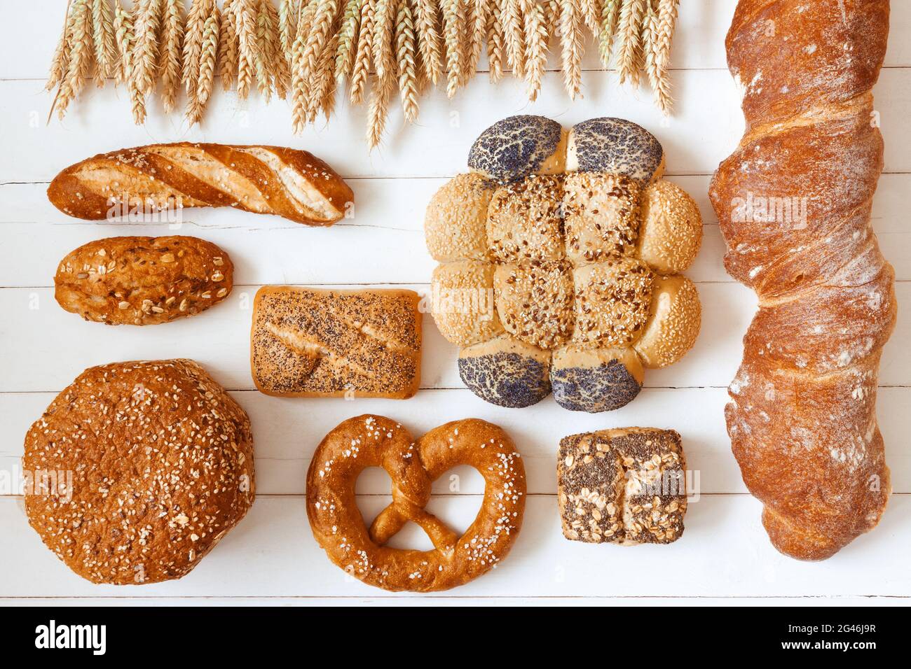 Assorted loafs of traditional breads and buns on a white background ...