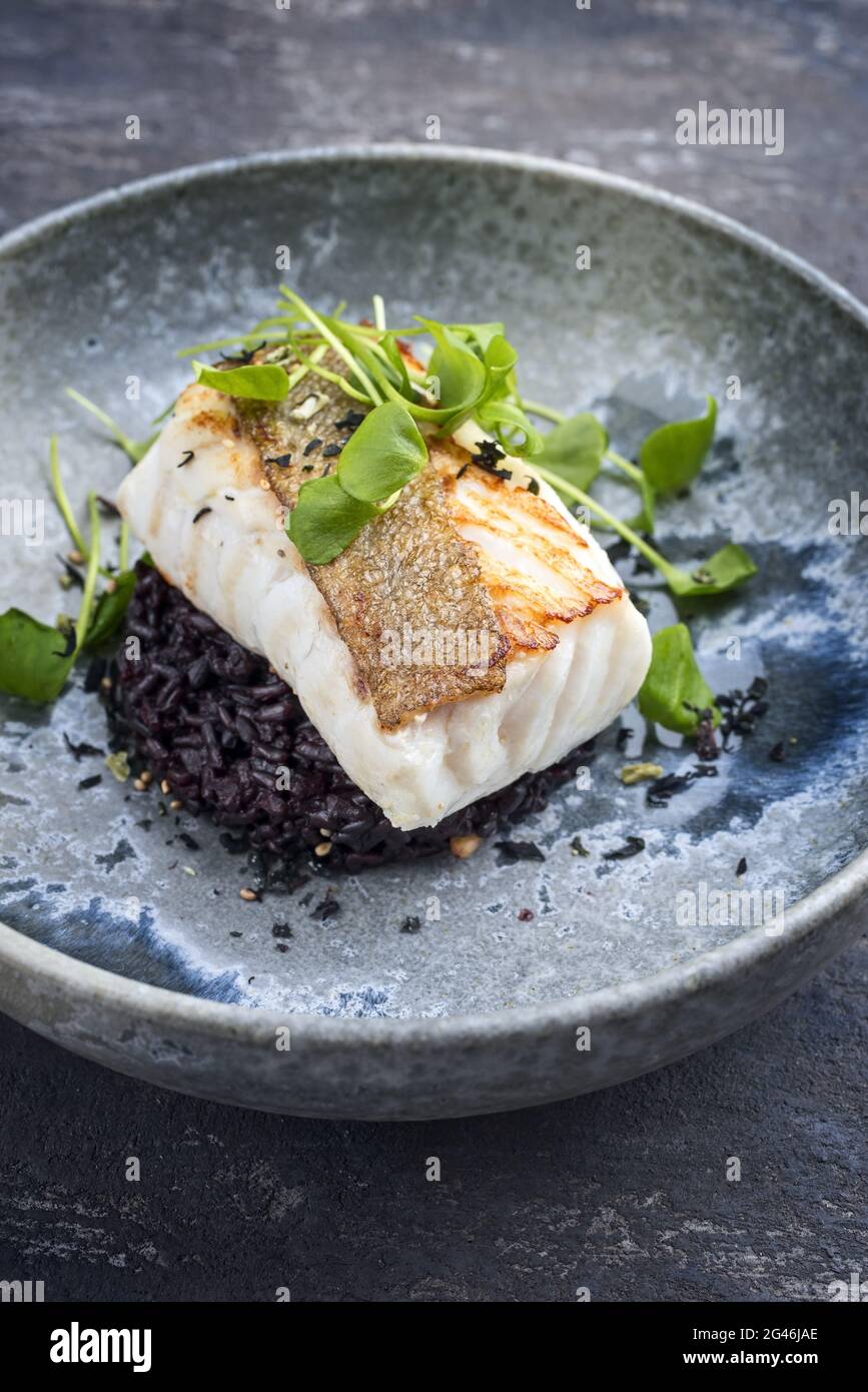 Modern style traditional fried skrei cod fish filet with portulaca ...