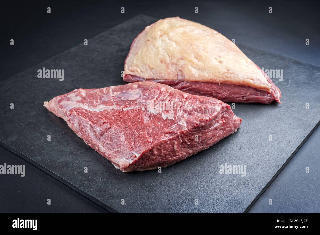 Raw dry aged wagyu cap of rump beef offered as close-up on black ...