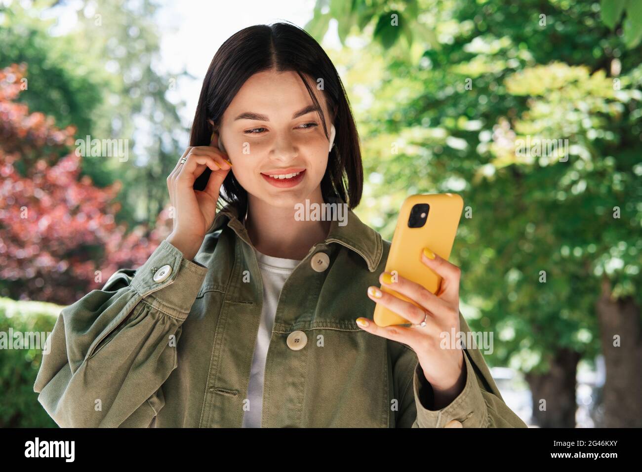 Young Woman Using Smartphone for Video Call While Walking in the City ...