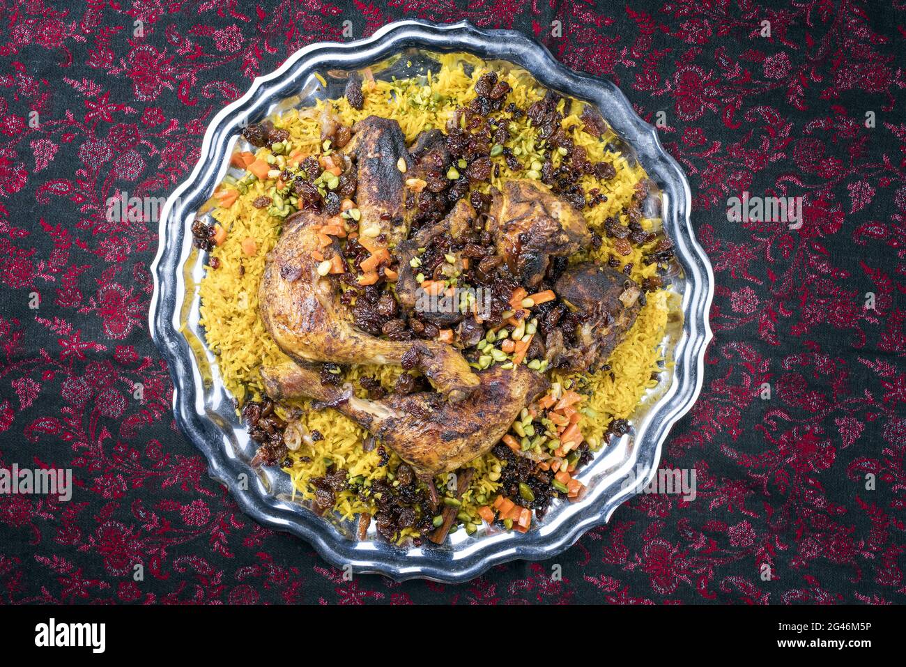 Traditional fried Arabic chicken majboos with chicken leg and jeweled ...