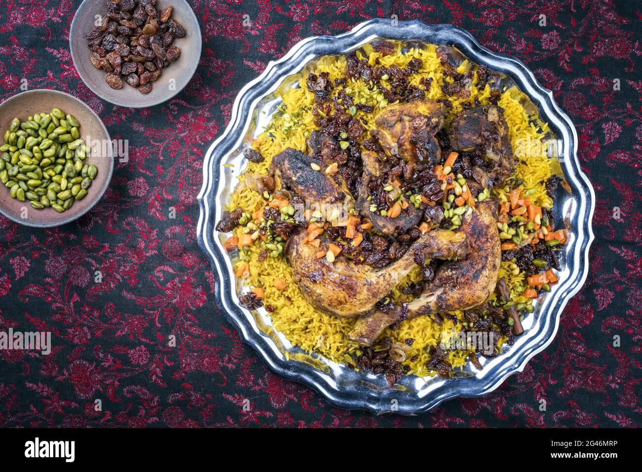 Traditional fried Arabic chicken majboos with chicken leg and jeweled ...