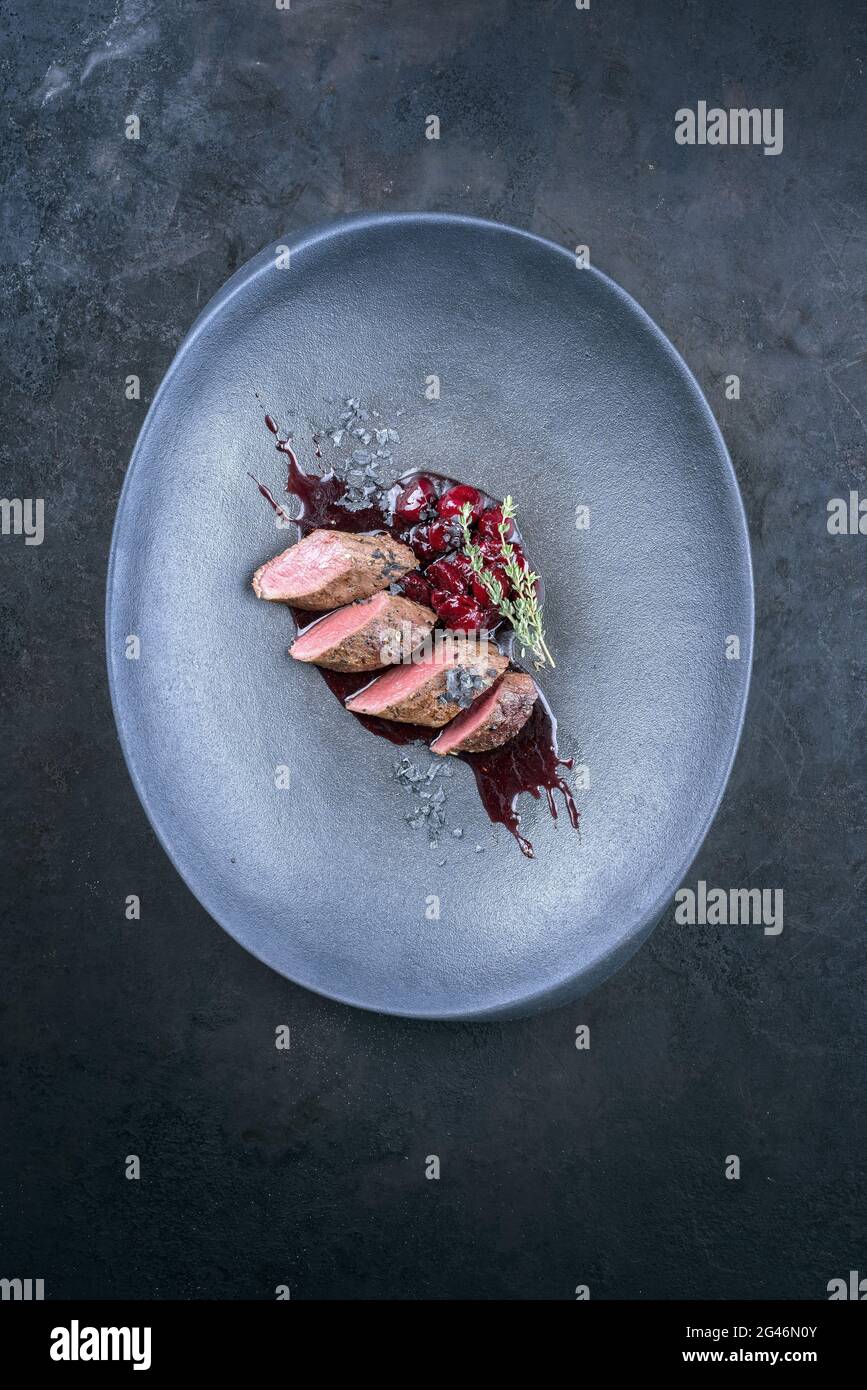 Modern style traditional wild hare back filet braised with wild berries ...