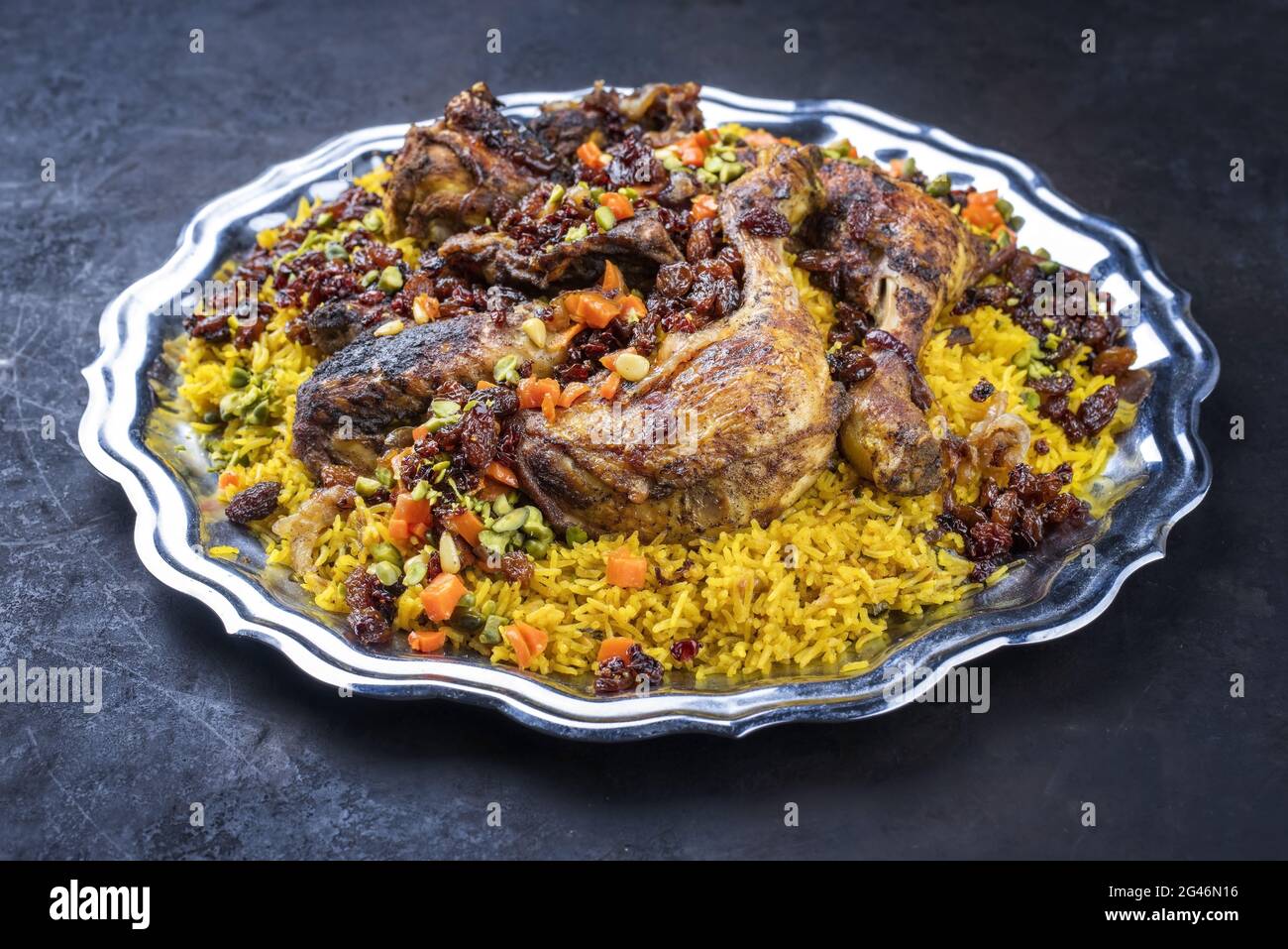 Traditional fried Arabic chicken majboos with chicken leg and jeweled ...