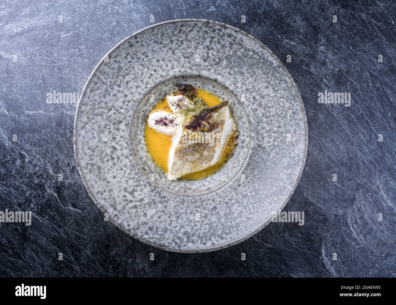 Modern style traditional sauteed skrei cod fish filet with skin with ...