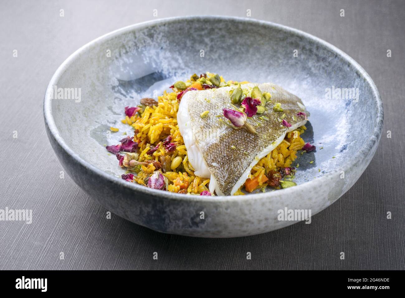 Modern style traditional sauteed skrei cod fish filet with skin in a ...