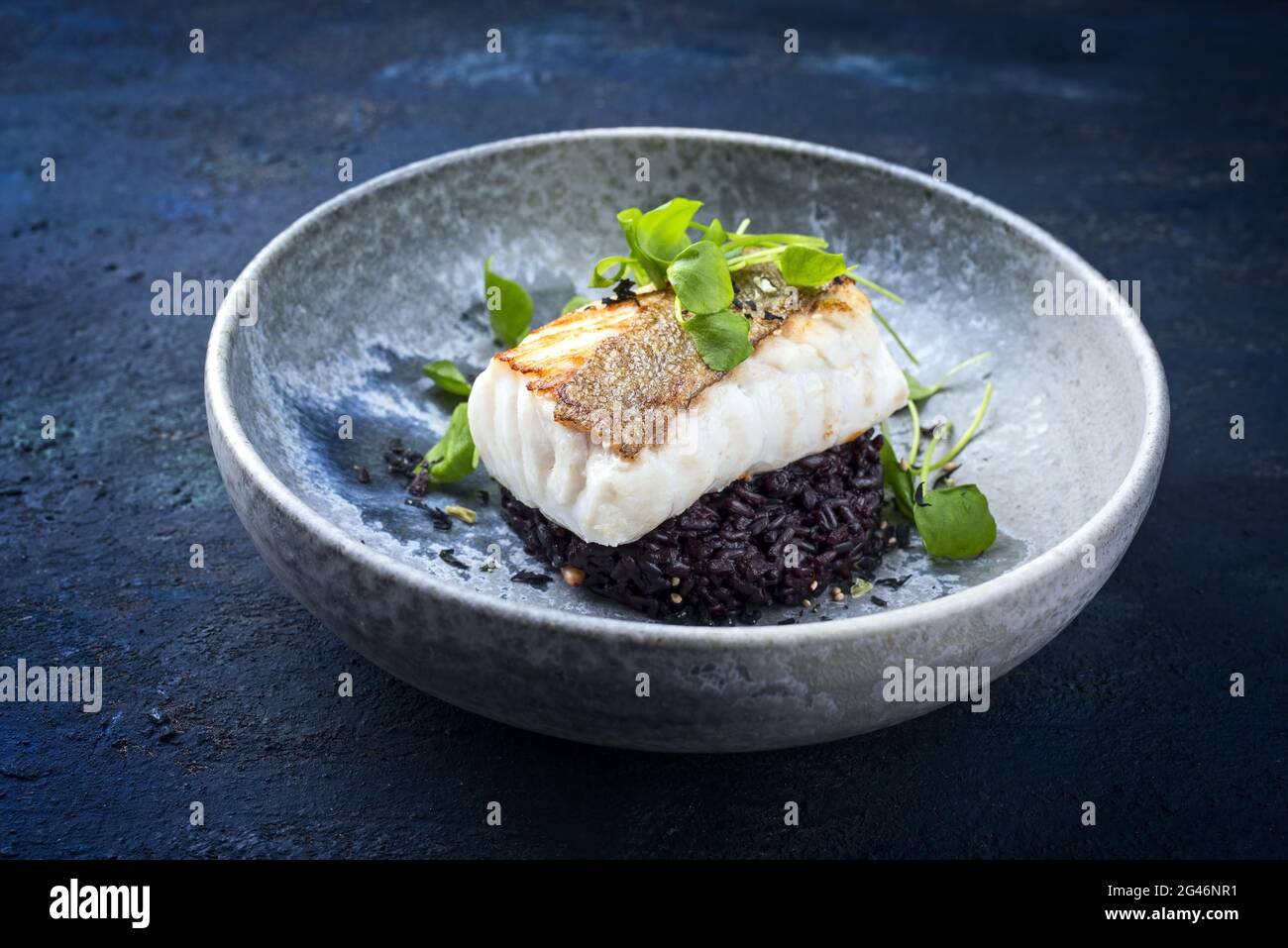 Modern style traditional fried skrei cod fish filet with portulaca ...