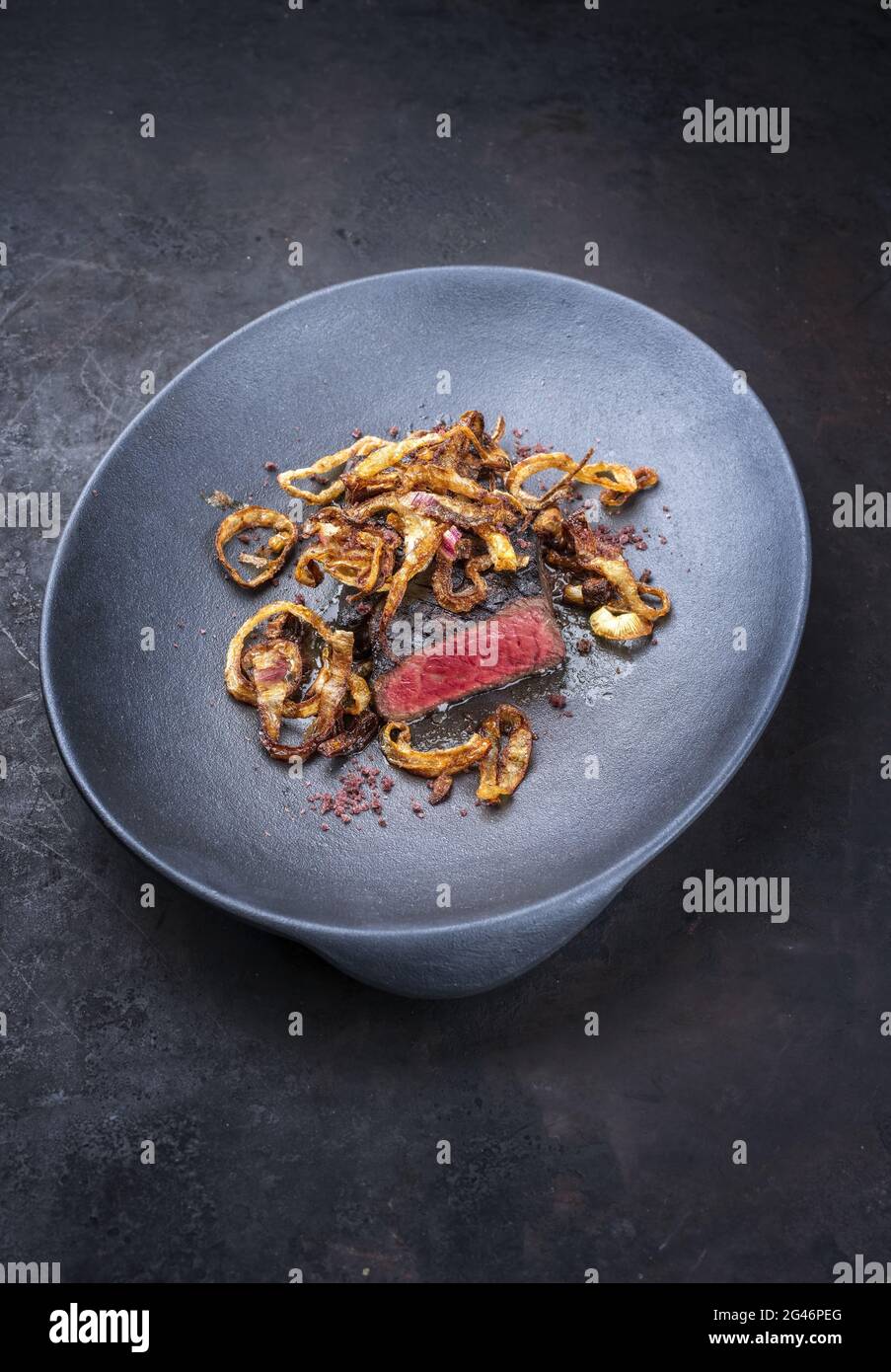 Modern style traditional dry aged sliced beef tenderloin with fried ...