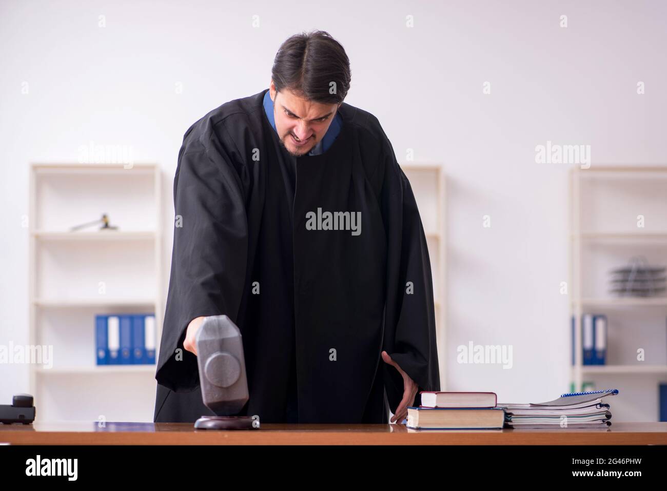 Young judge working in the courtroom Stock Photo - Alamy