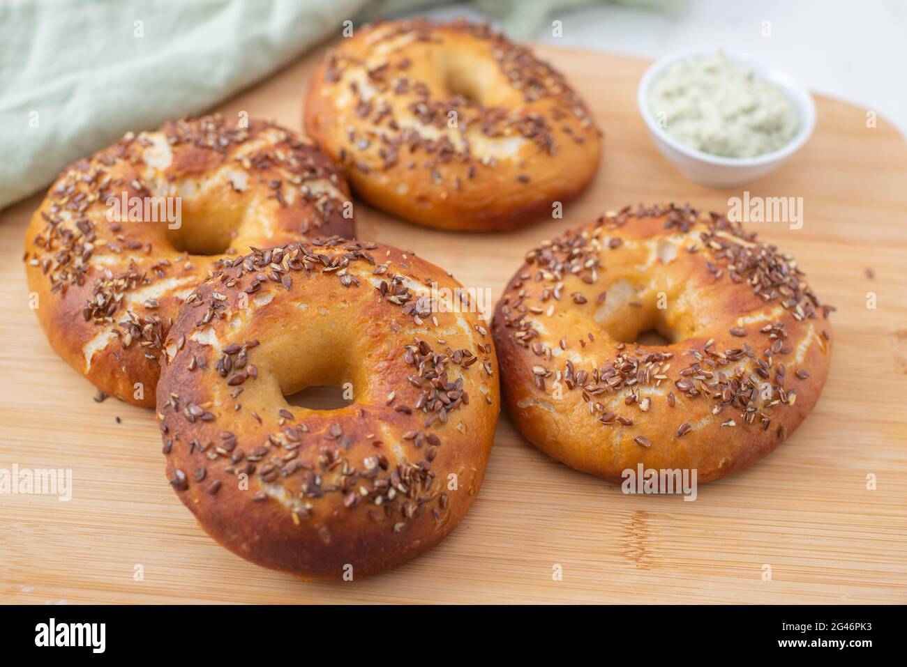 Freshly baked whole grain bagels. heap of fresh baked bagels on a table ...