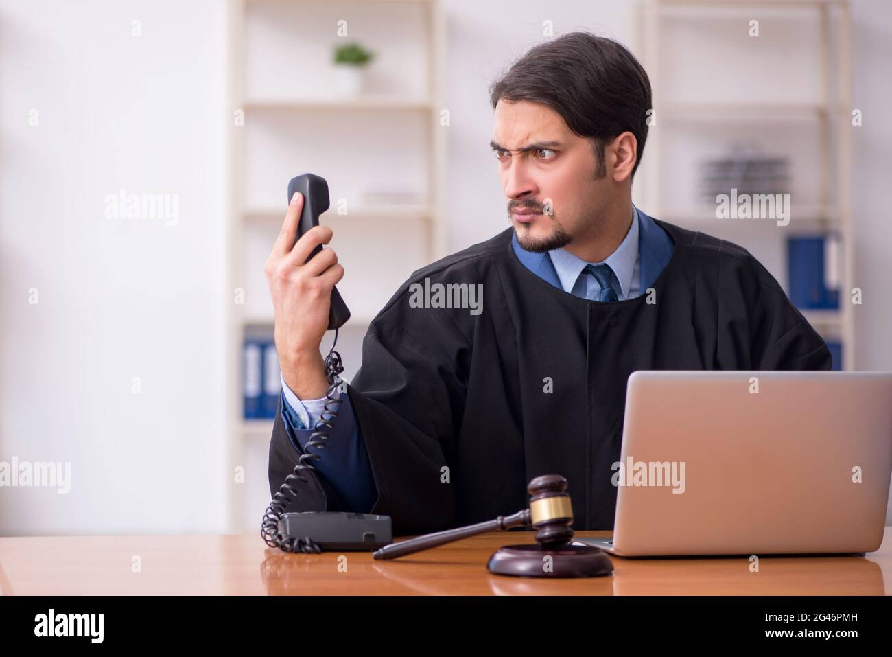 Young judge working in the courtroom Stock Photo - Alamy