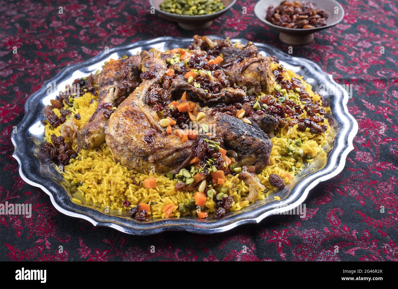 Traditional fried Arabic chicken majboos with chicken leg and jeweled ...