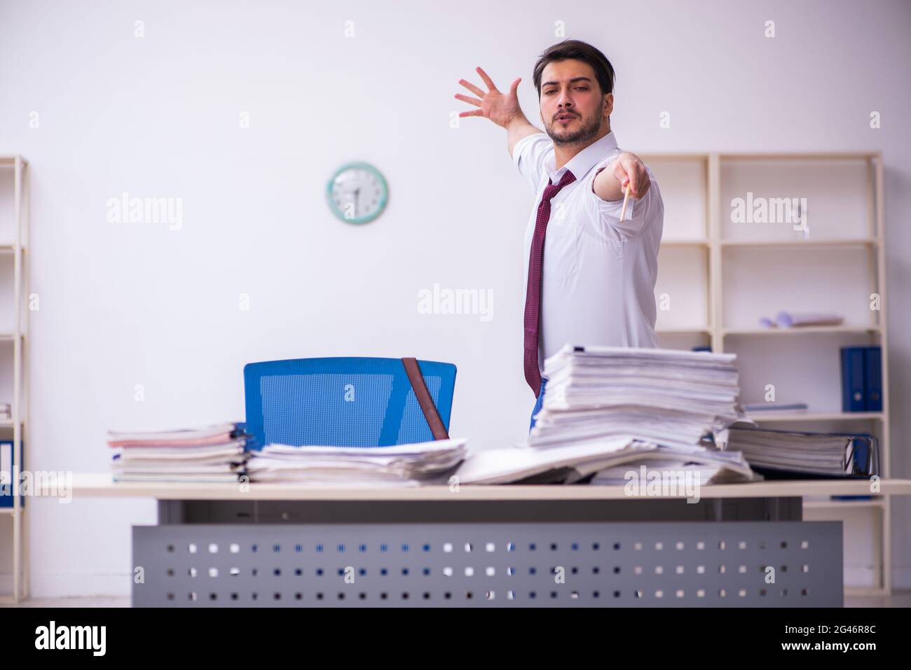 Funny young employee magician and too much work in the office Stock ...