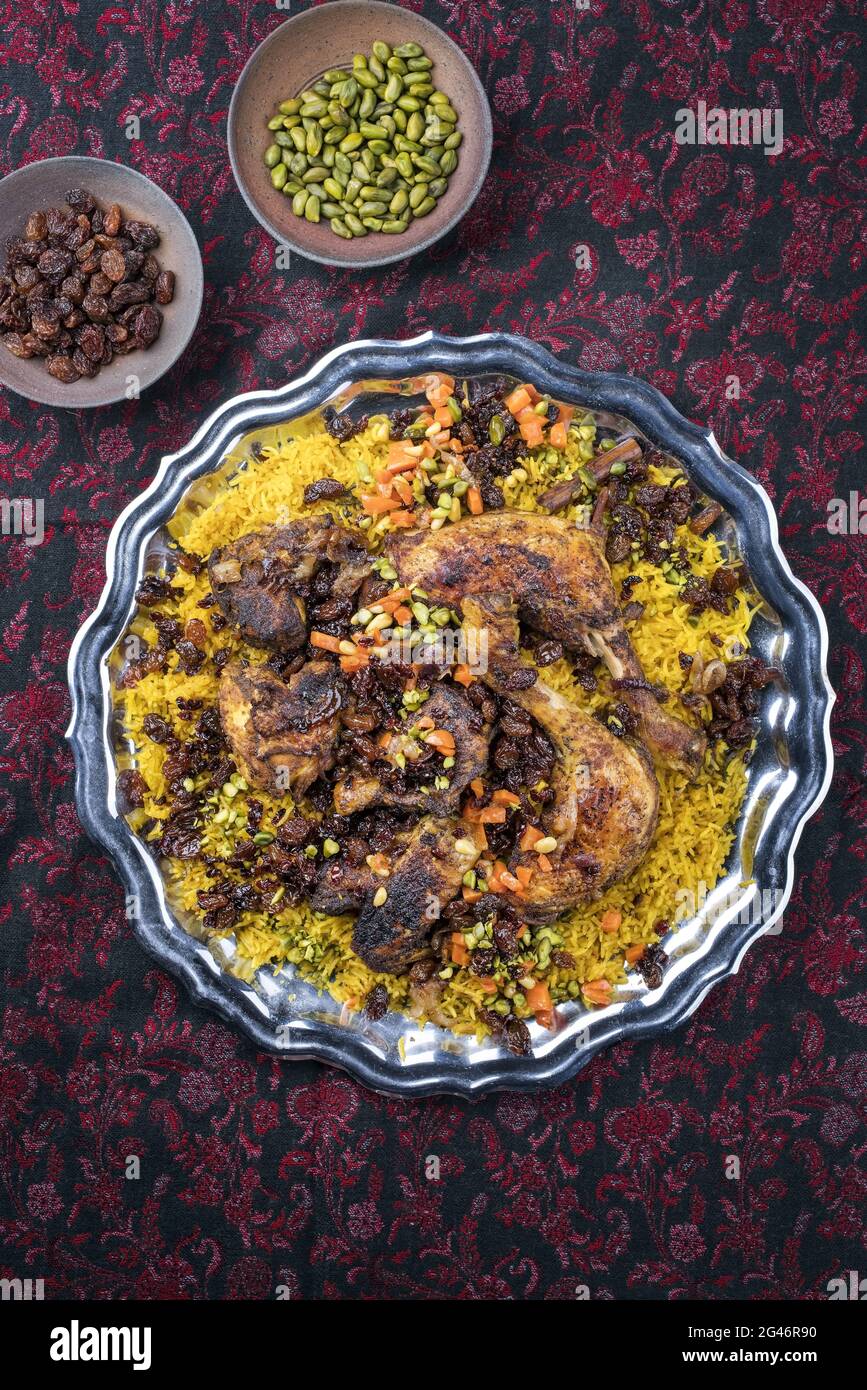 Traditional fried Arabic chicken majboos with chicken leg and jeweled ...