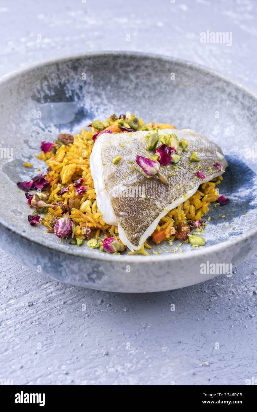Modern style traditional sauteed skrei cod fish filet with skin in a ...