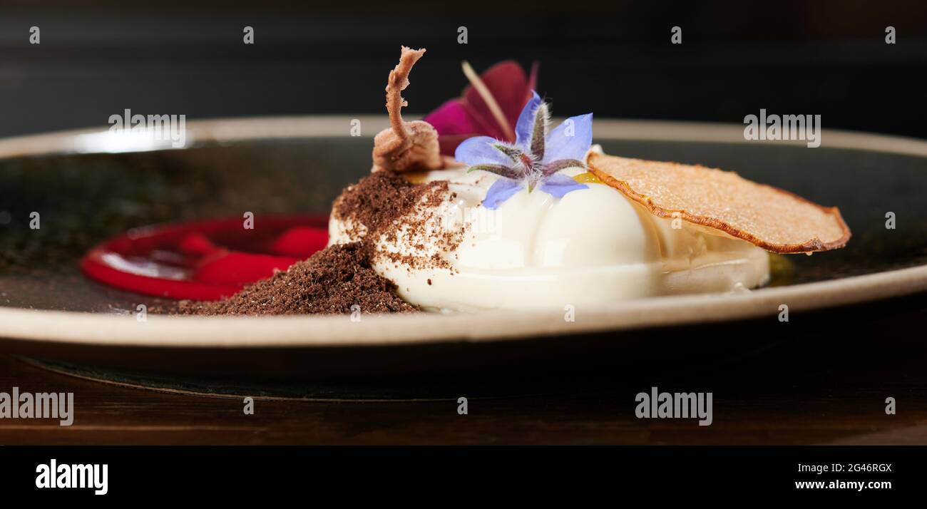 Panna cotta dessert with flower and chocolate macro view Stock Photo ...