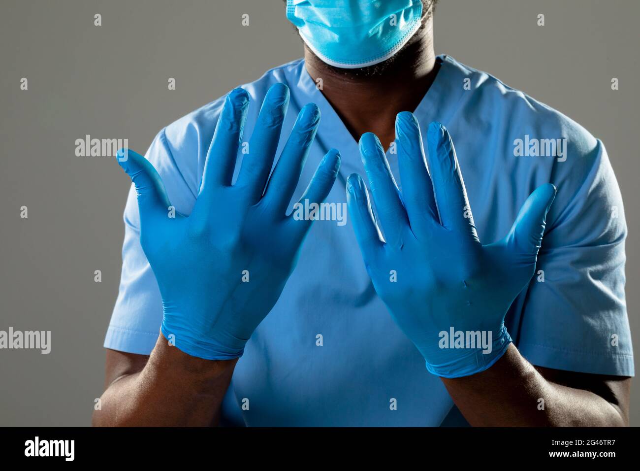 Mid section of african american male health worker wearing surgical ...