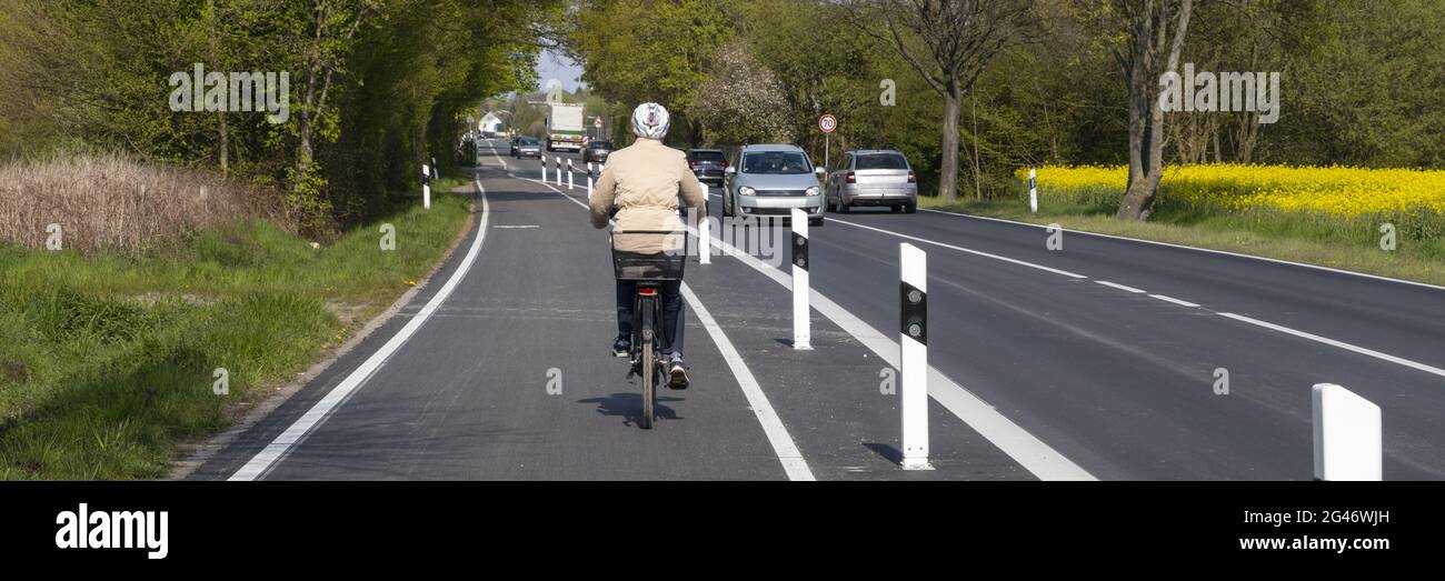 Bicycle rider on a cycle path with pole, North Rhine-Westphalia ...