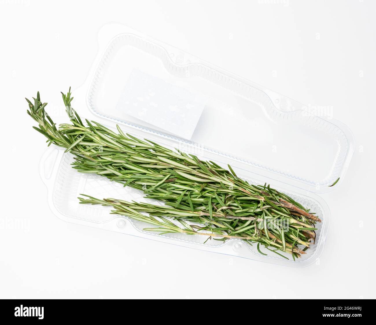 Sprigs of fresh rosemary in a transparent plastic package on a white ...