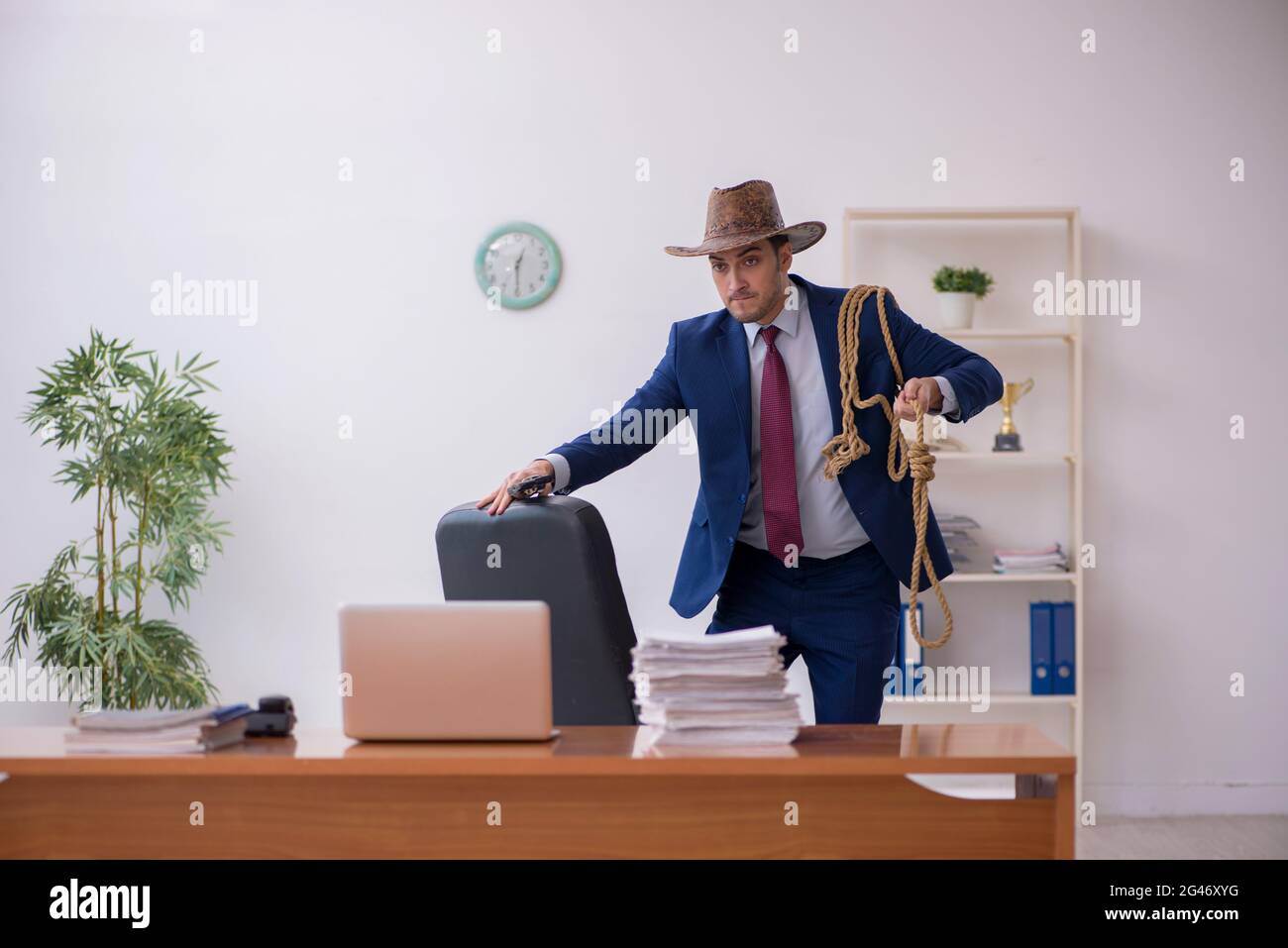Young cowboy employee working at workplace Stock Photo - Alamy