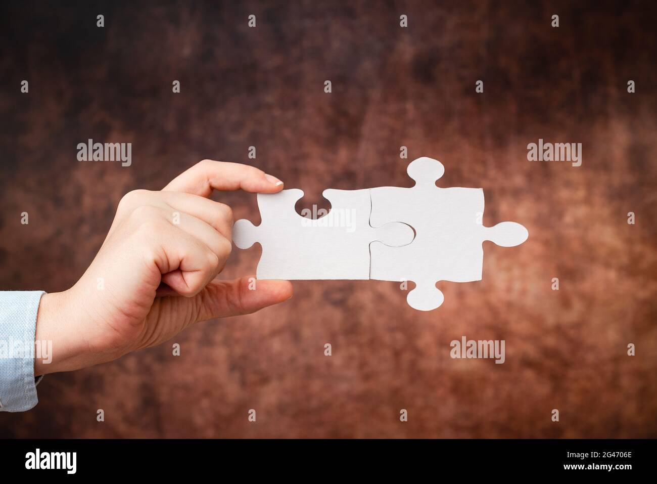 Hands Holding Two Pieces Of Jigsaw Puzzle.Cooperation For Finding And ...