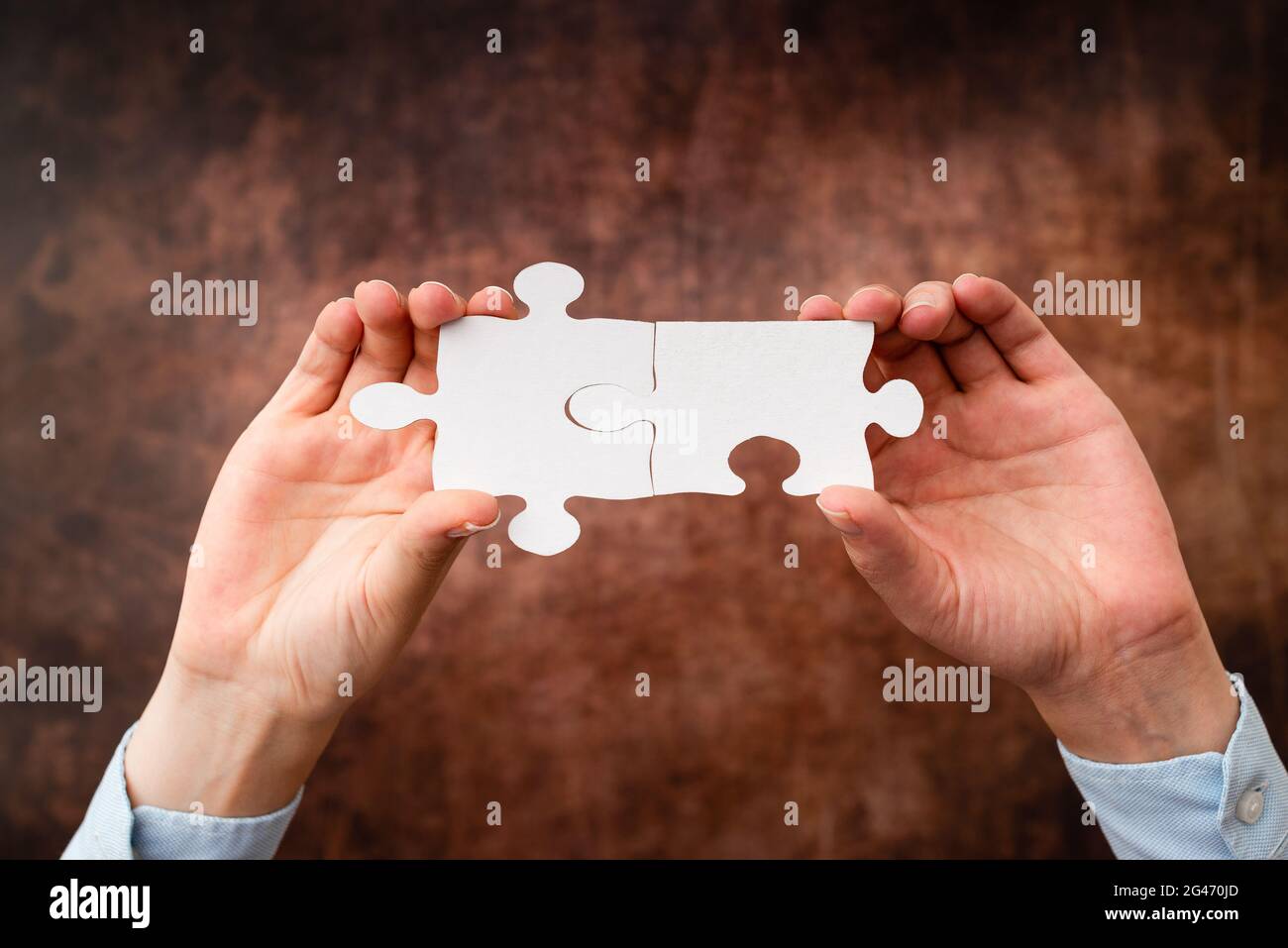 Hands Holding Two Pieces Of Jigsaw Puzzle.Cooperation For Finding And ...