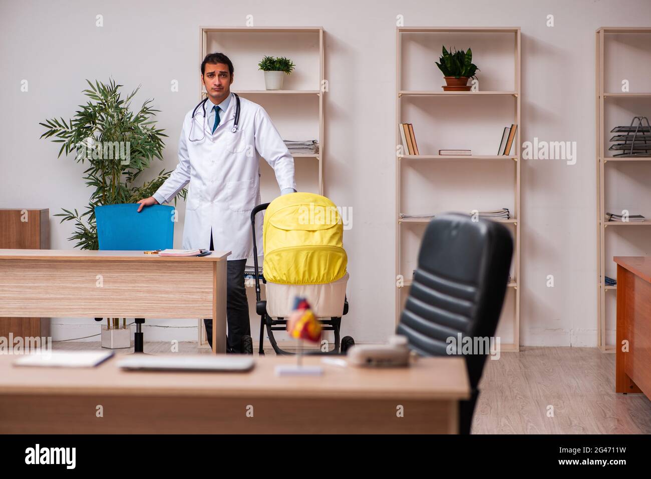 Young male doctor looking after new born at the hospital Stock Photo ...