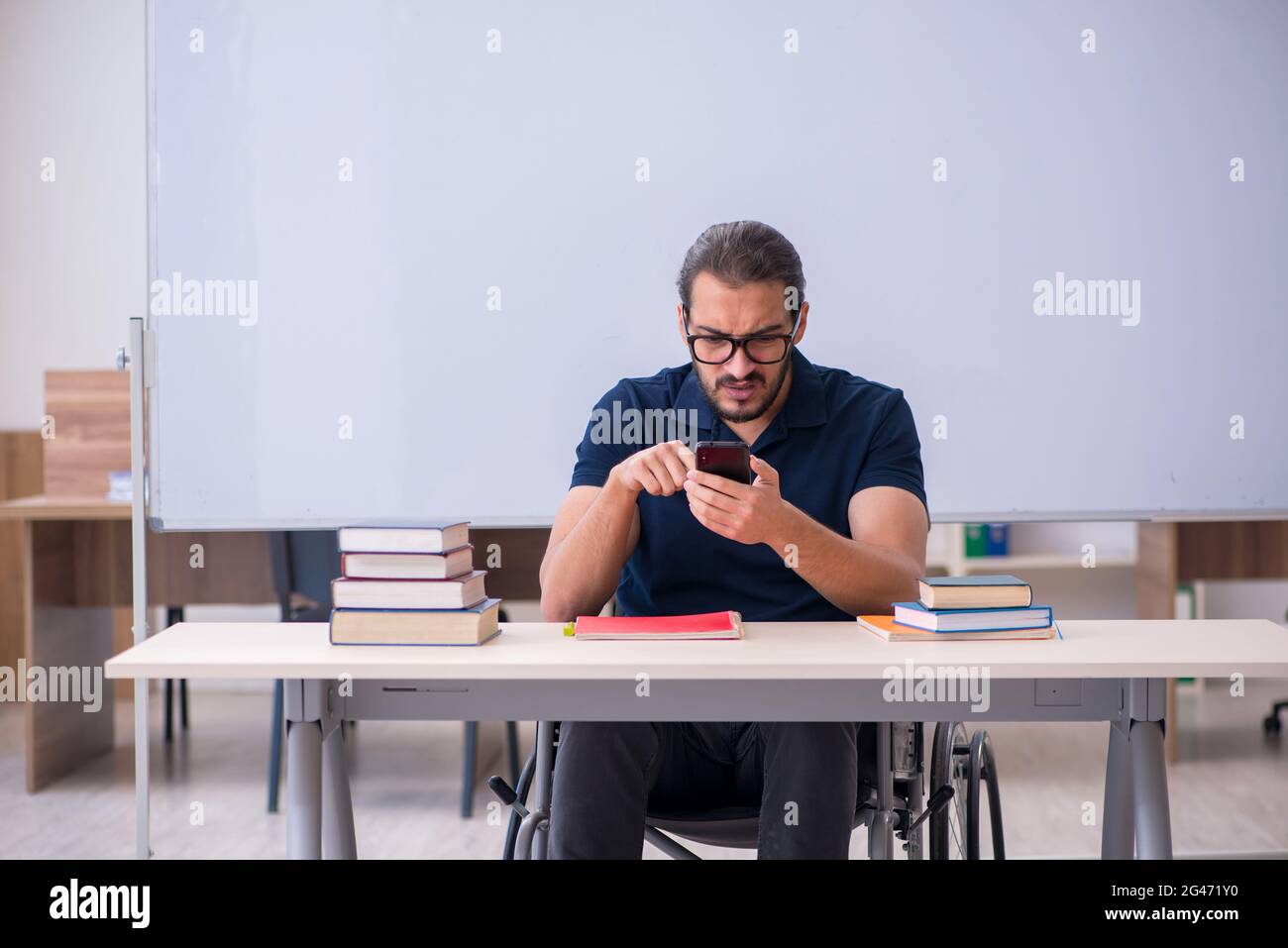 Young handicapped student in the classroom Stock Photo - Alamy