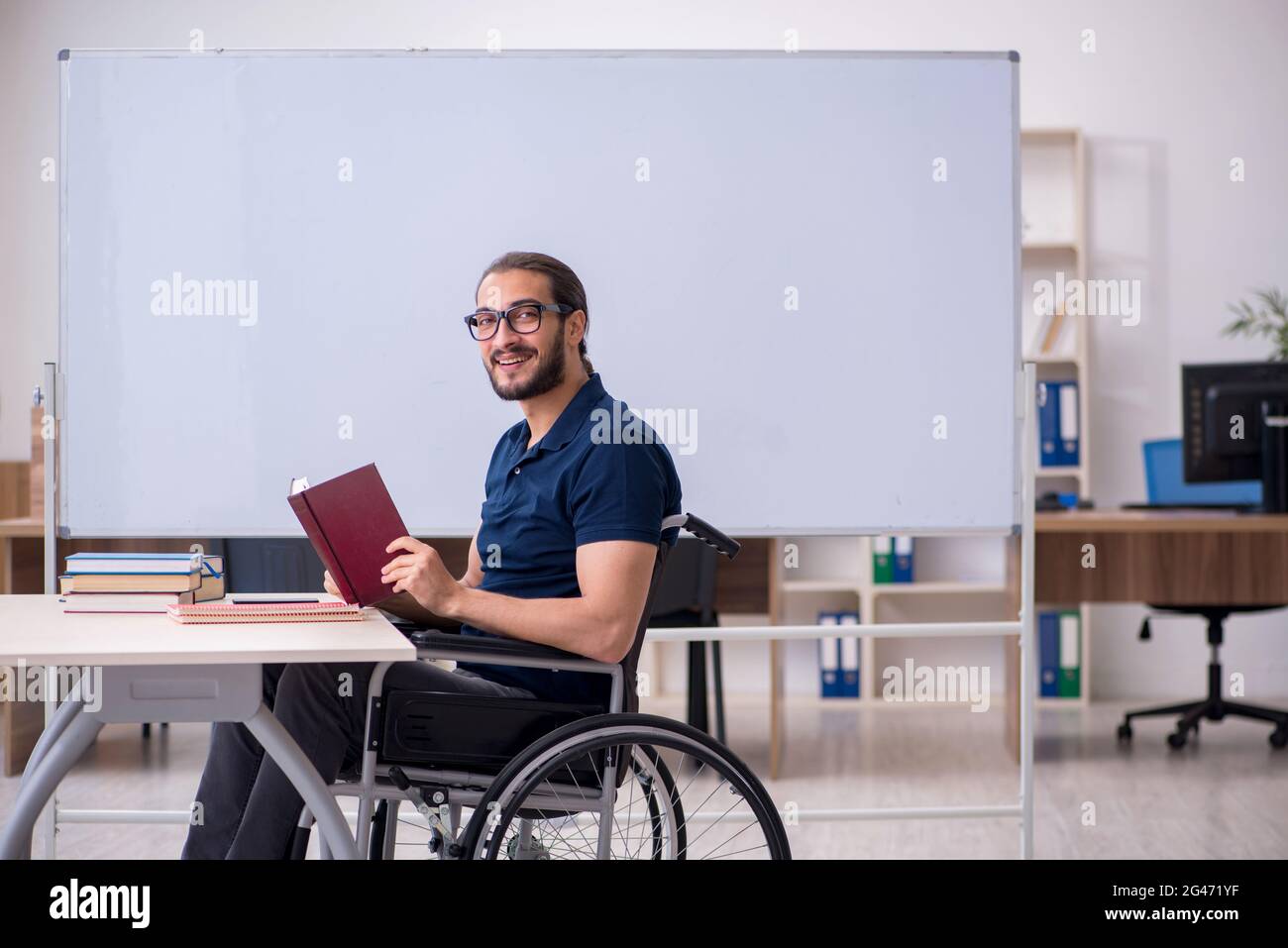 Young handicapped student in the classroom Stock Photo - Alamy