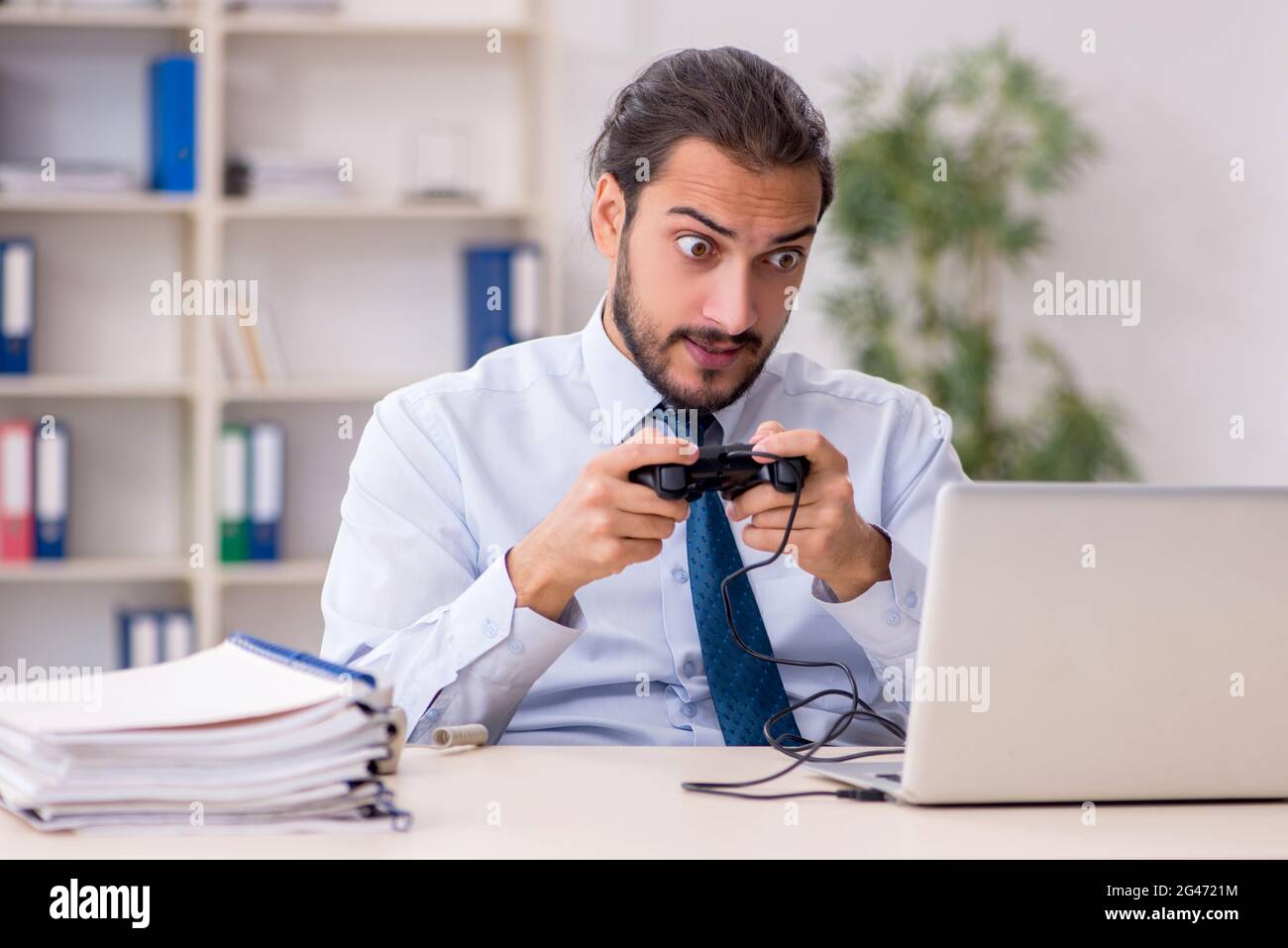 Young employee playing joystick hi-res stock photography and images - Alamy