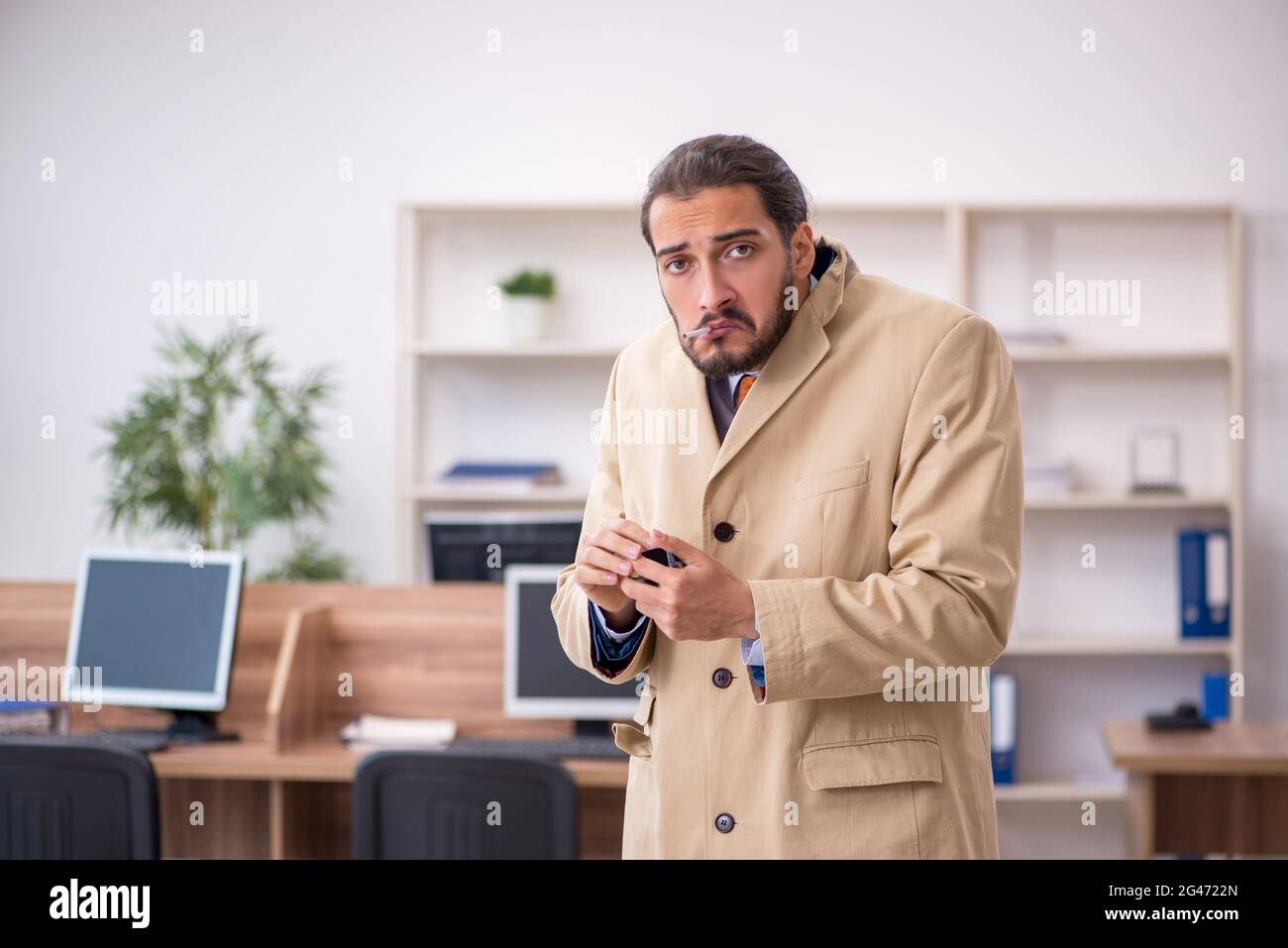 Sick cigarette addicted male employee working in the office Stock Photo ...