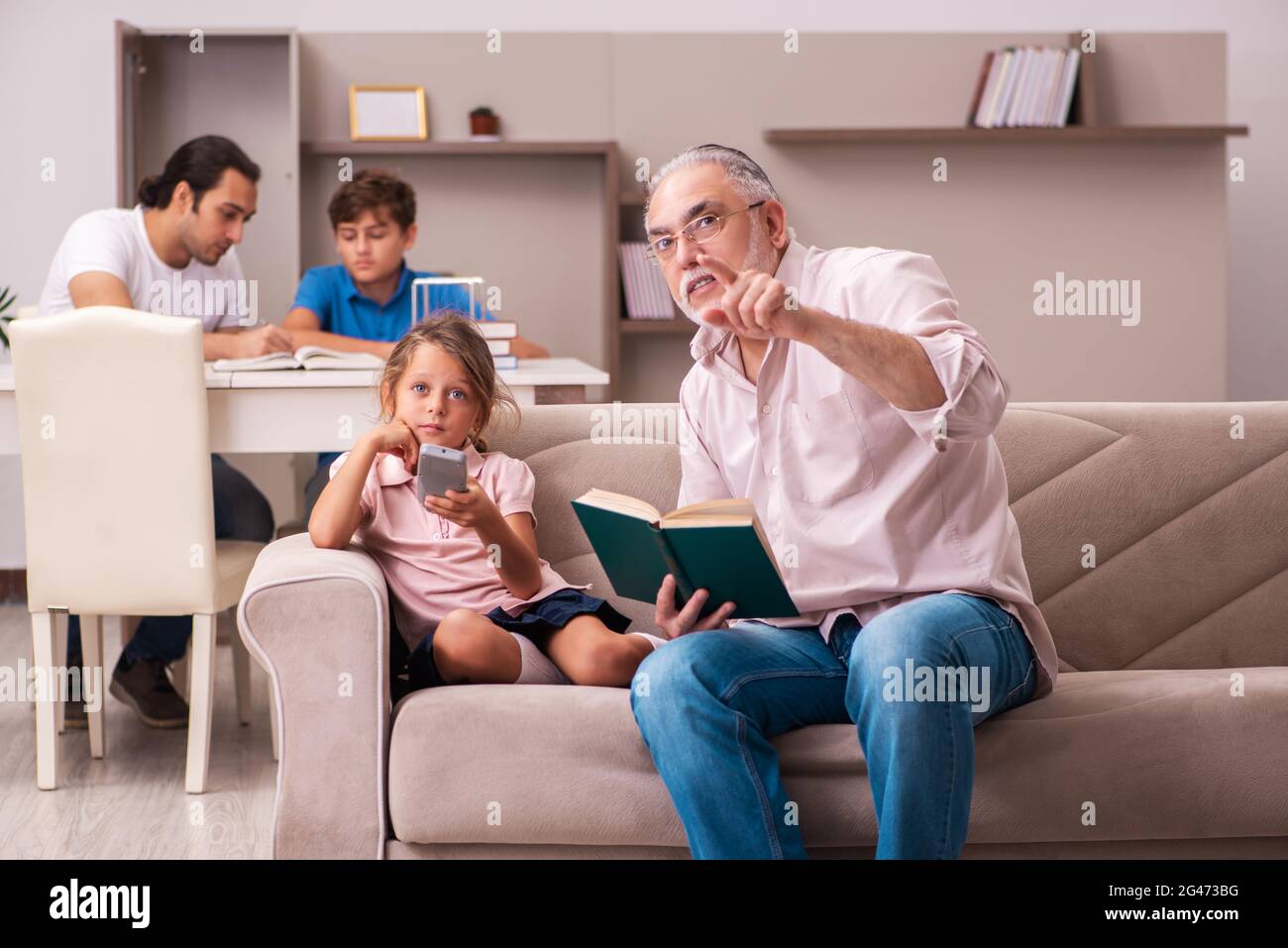 Three generations family watching tv hi-res stock photography and ...